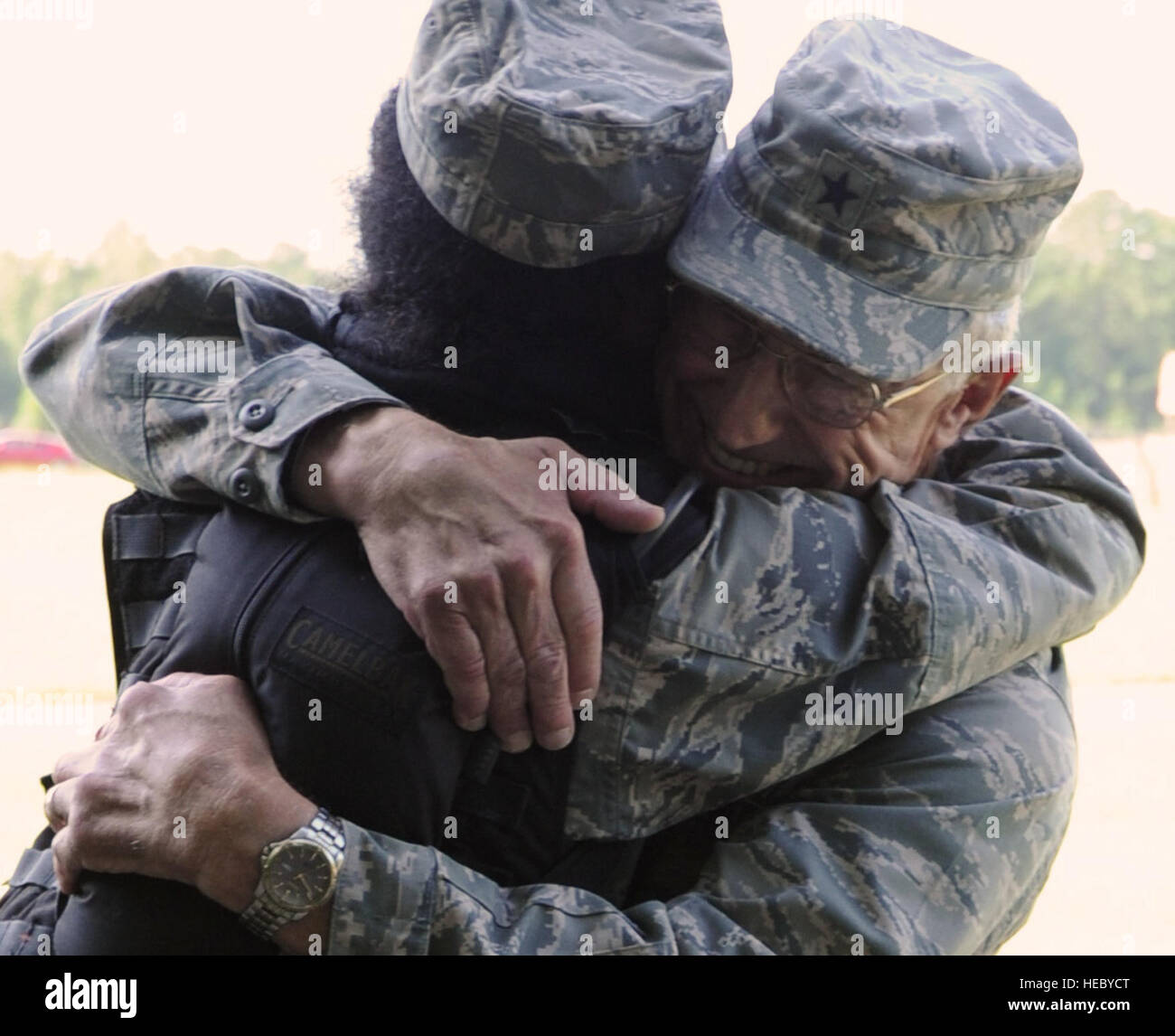 Retired Brig. Gen. James Sehorn hugs an Airman during a motivational ...