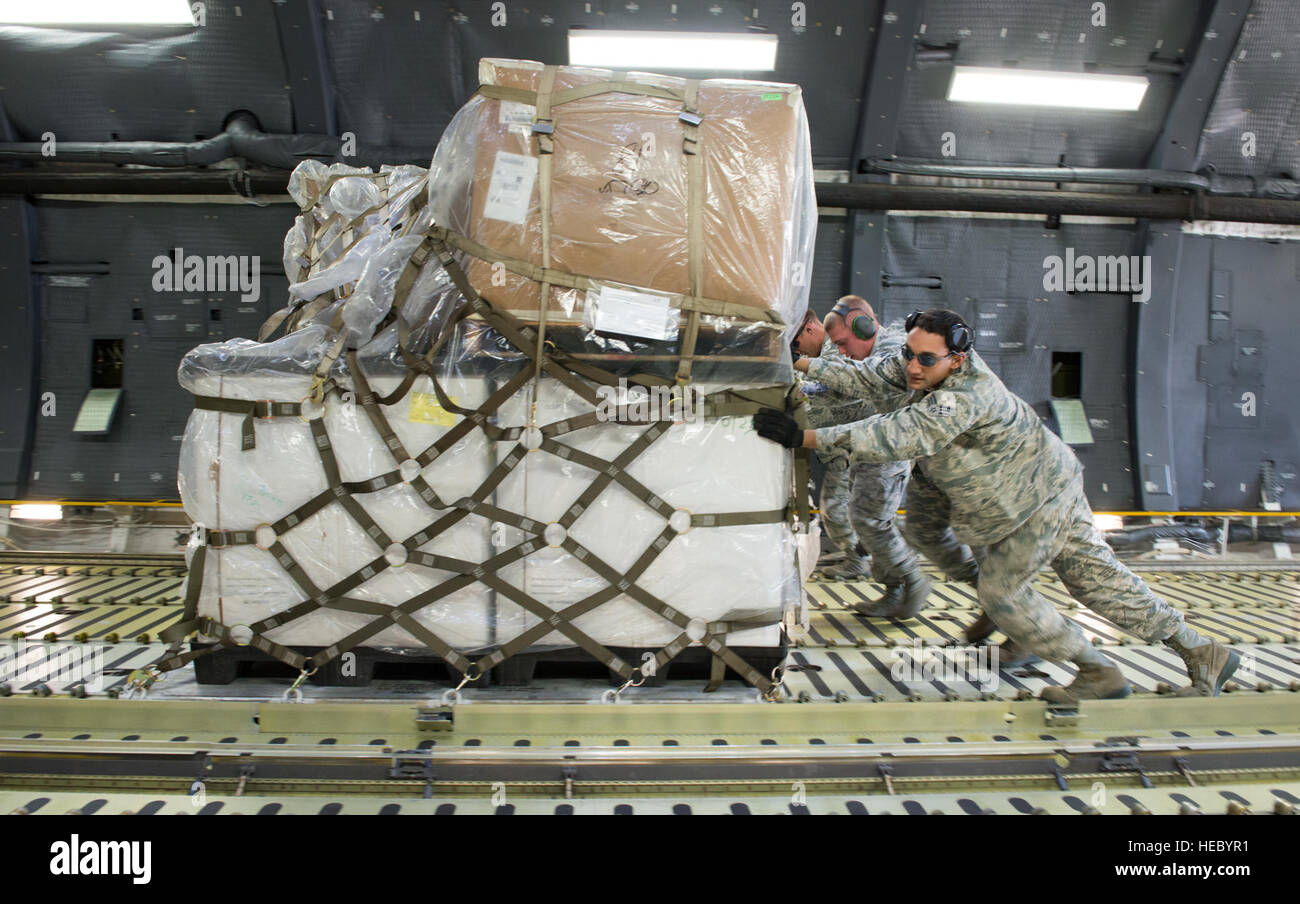 Airmen from the 60th Aerial Port Squadron push a pallet full of ropes ...