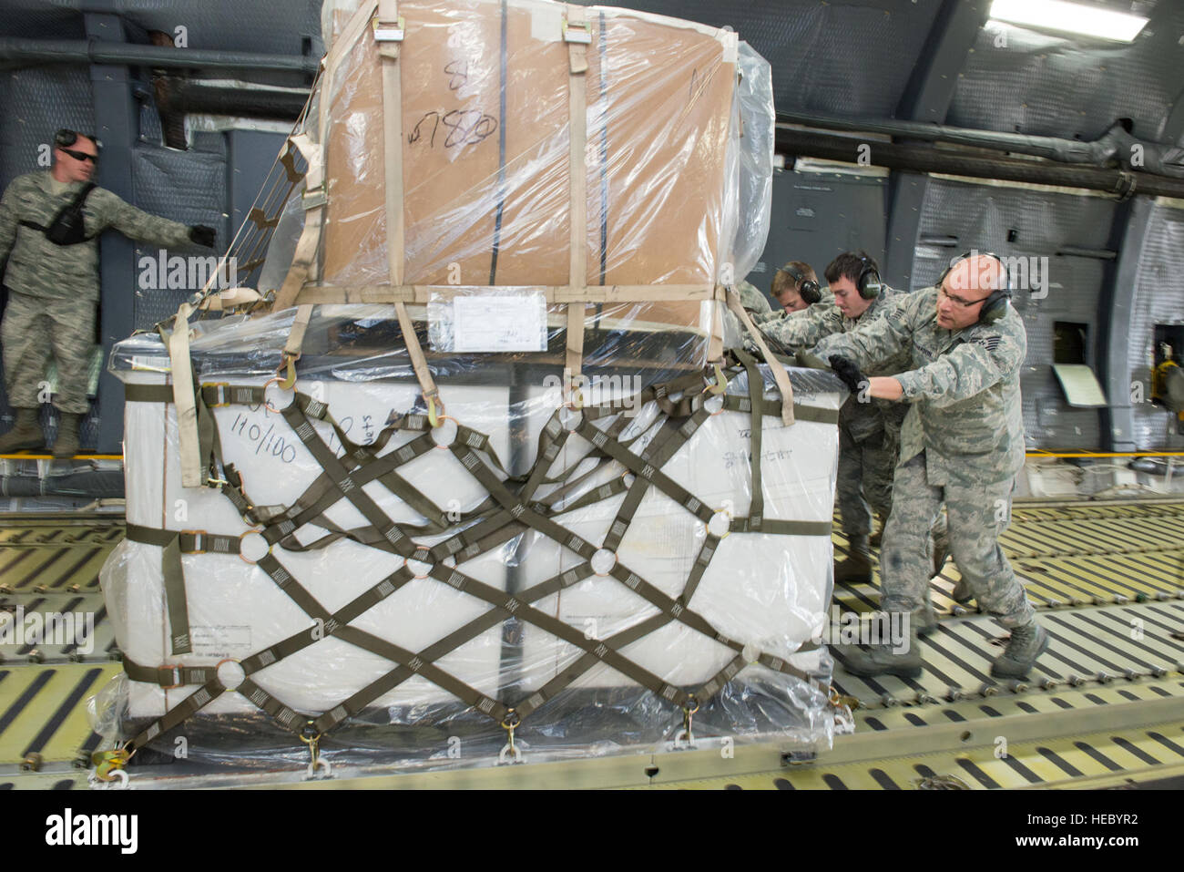 Airmen from the 60th Aerial Port Squadron push a pallet full of ropes ...