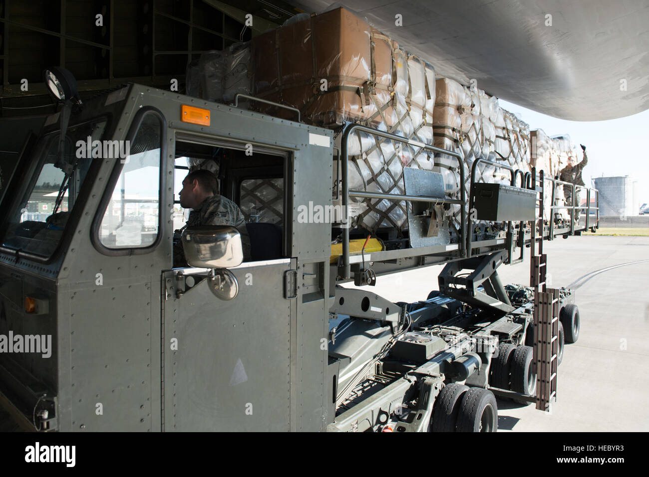 Airmen from the 60th Aerial Port Squadron push a pallet full of ropes ...