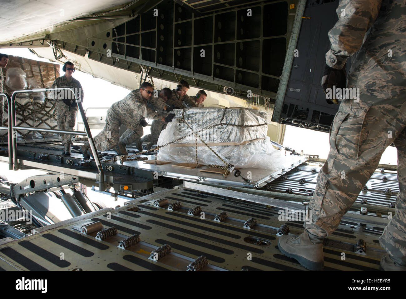 Airmen from the 60th Aerial Port Squadron push a pallet full of ropes ...
