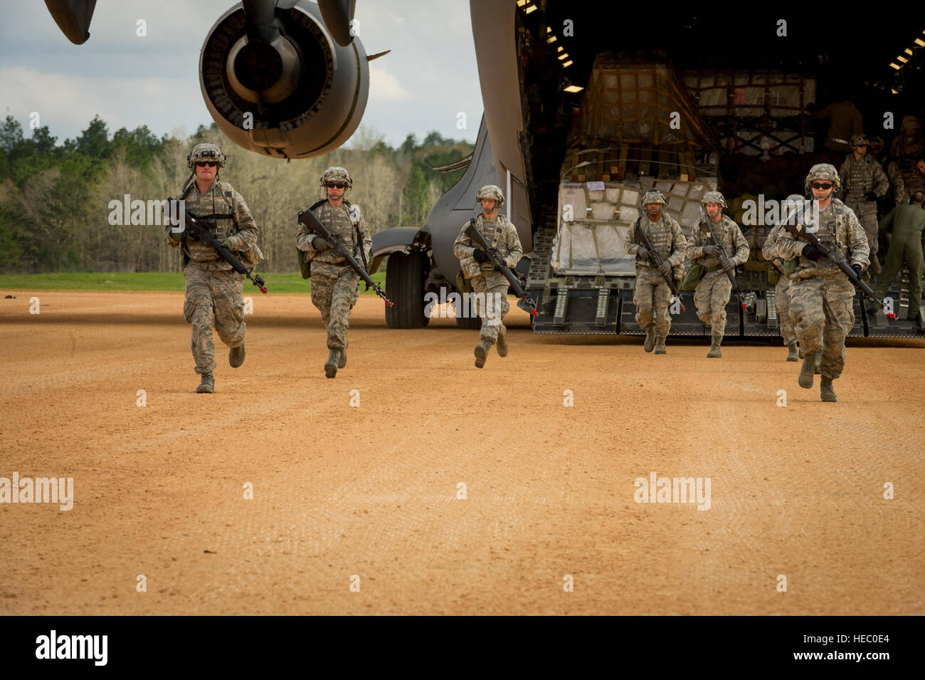 U.S. aeromedical evacuation Airmen exit a C-17 Globemaster III aircraft ...