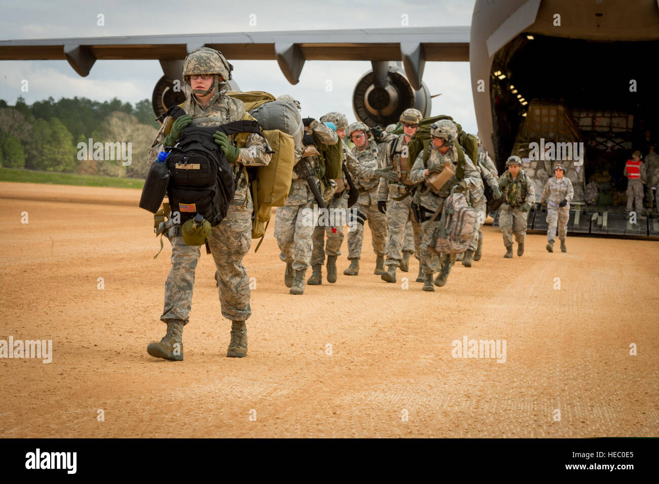 U.S. aeromedical evacuation Airmen exit the back of a C-17 Globemaster ...