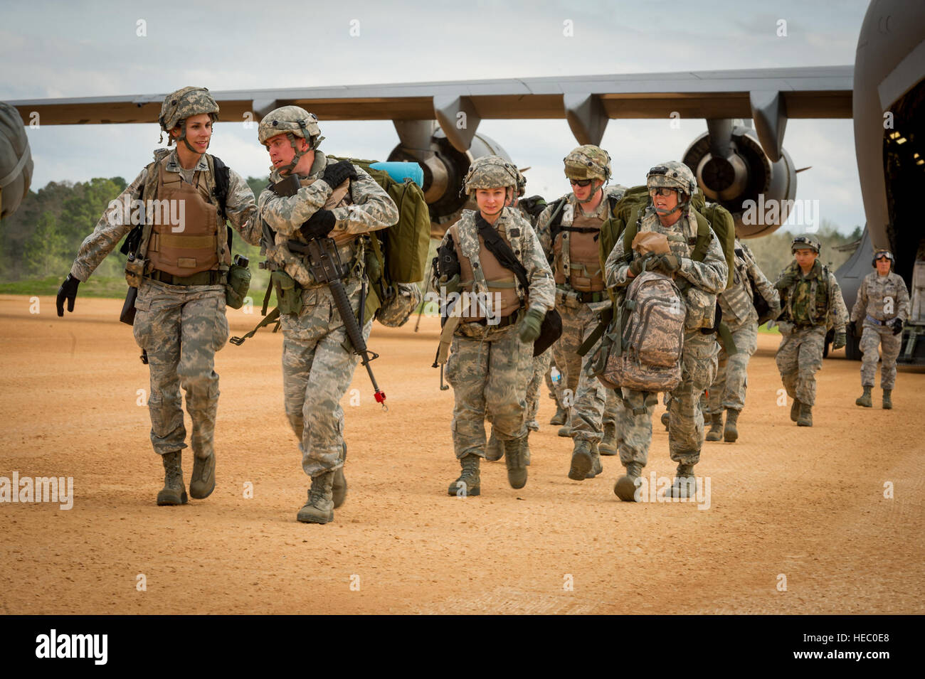 U.S. aeromedical evacuation Airmen exit the back of a C-17 Globemaster ...