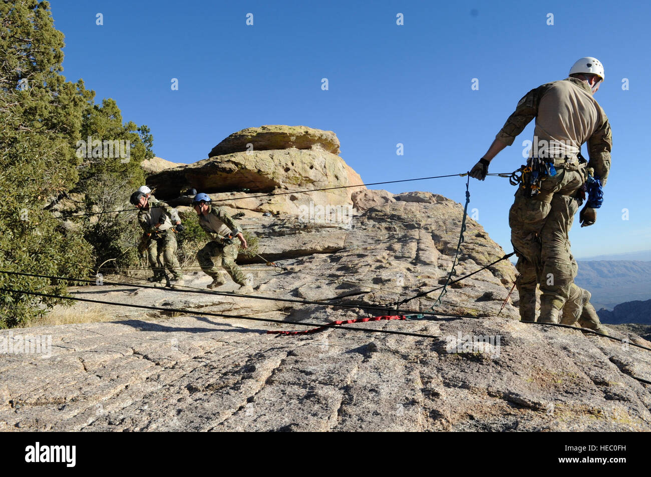 U.S. Airmen assigned to the 48th Rescue Squadron hoist a simulated ...