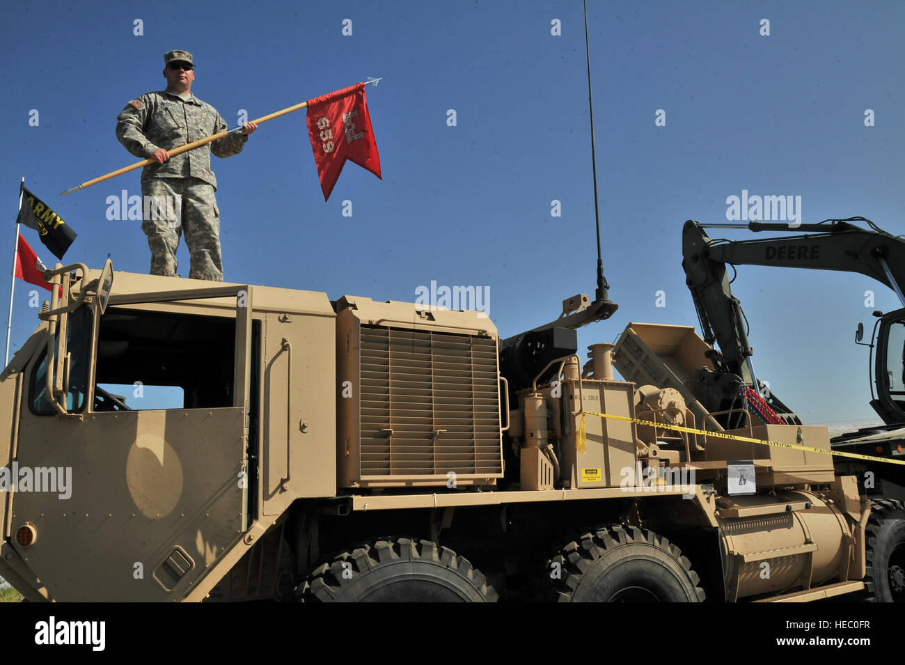 Sergeant Aaron Willieford, 658th Engineer Unit, hold thier guidon ontop ...