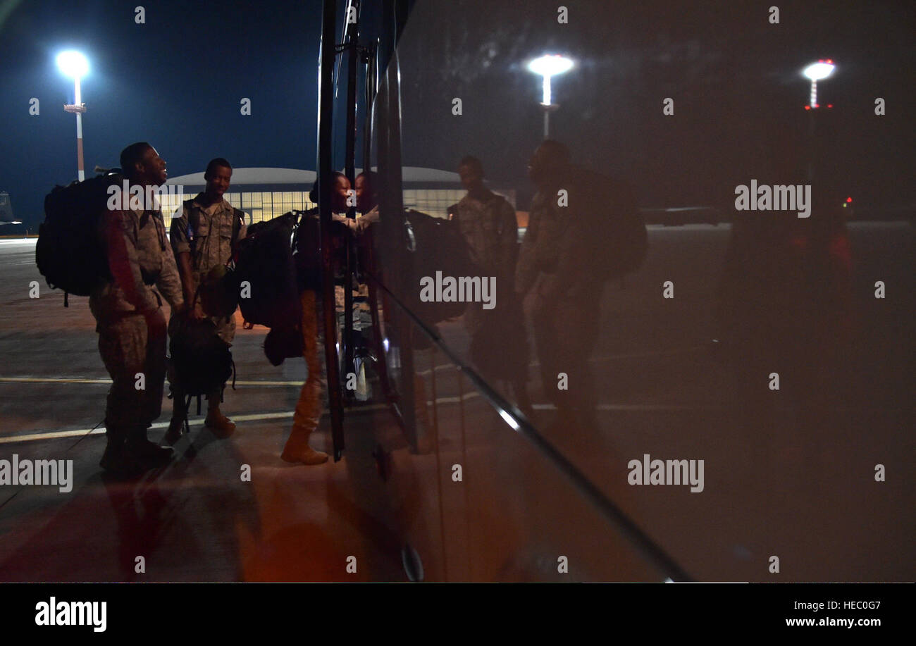 U.S. Airmen board a bus on the flight line after arriving at Ramstein ...