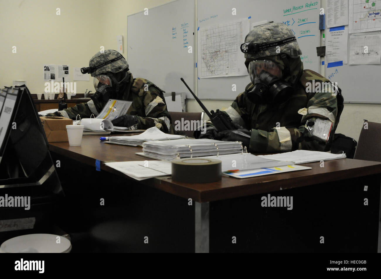 U.S. Airmen clad in chemical protective overgarments coordinate post ...