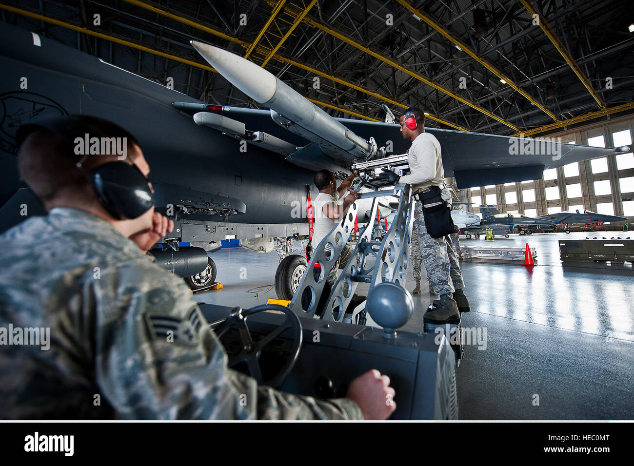 Airmen from the 96th Aircraft Maintenance Squadron load an AIM-120 ...