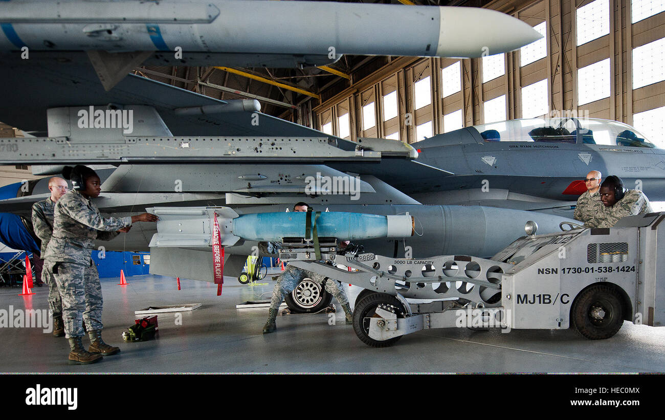U.S. Airmen with the 96th Aircraft Maintenance Squadron load a guided ...