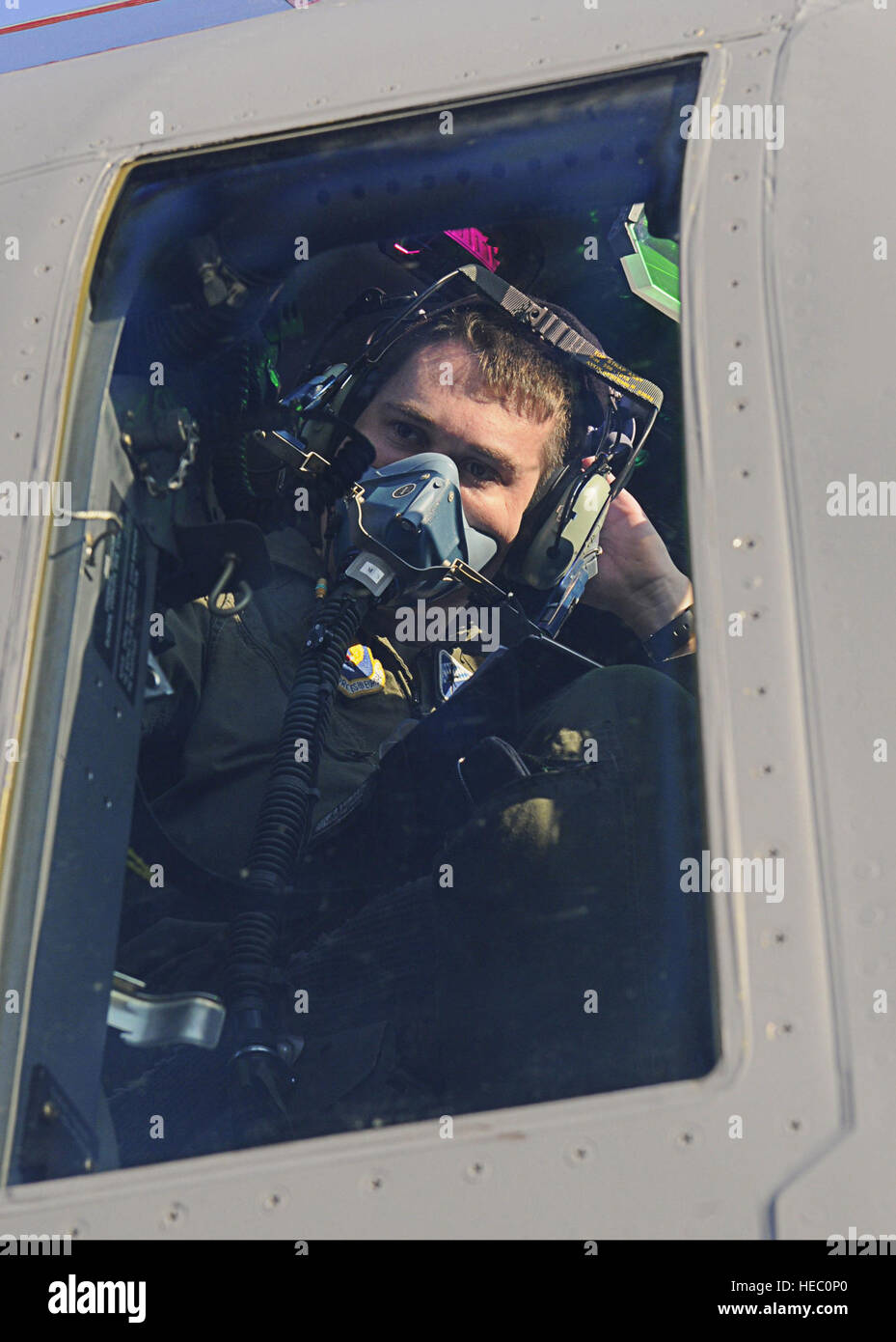 An airlift squadron pilot inspects his oxygen mask before deployment in ...