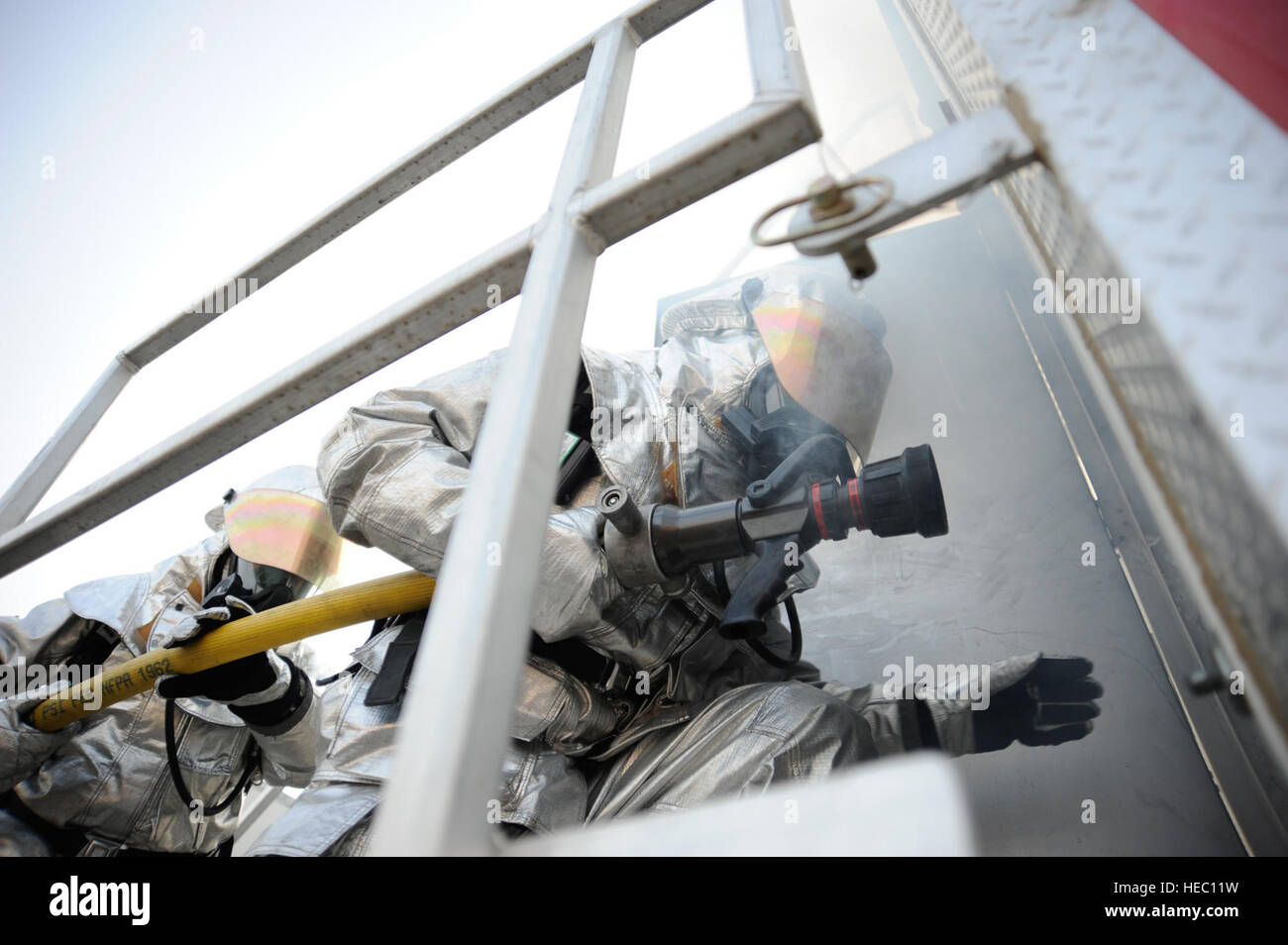 Iraqi firefighters enter a mobile training unit to extinguish a fire ...