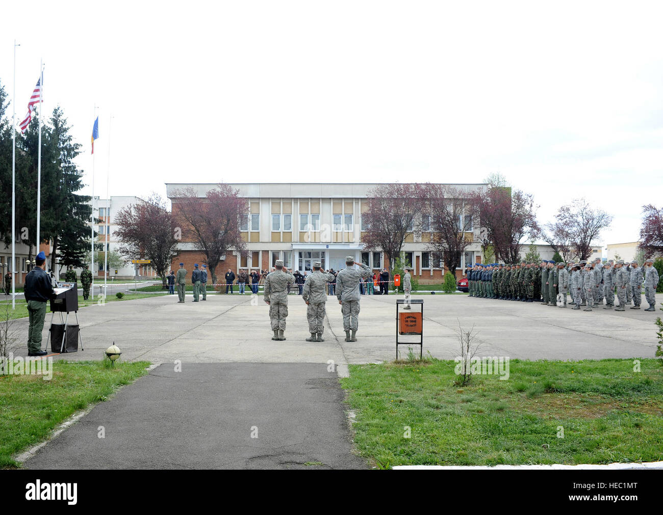 U.S. and Romanian airmen salute as the Romanian flag is raised April 10 ...
