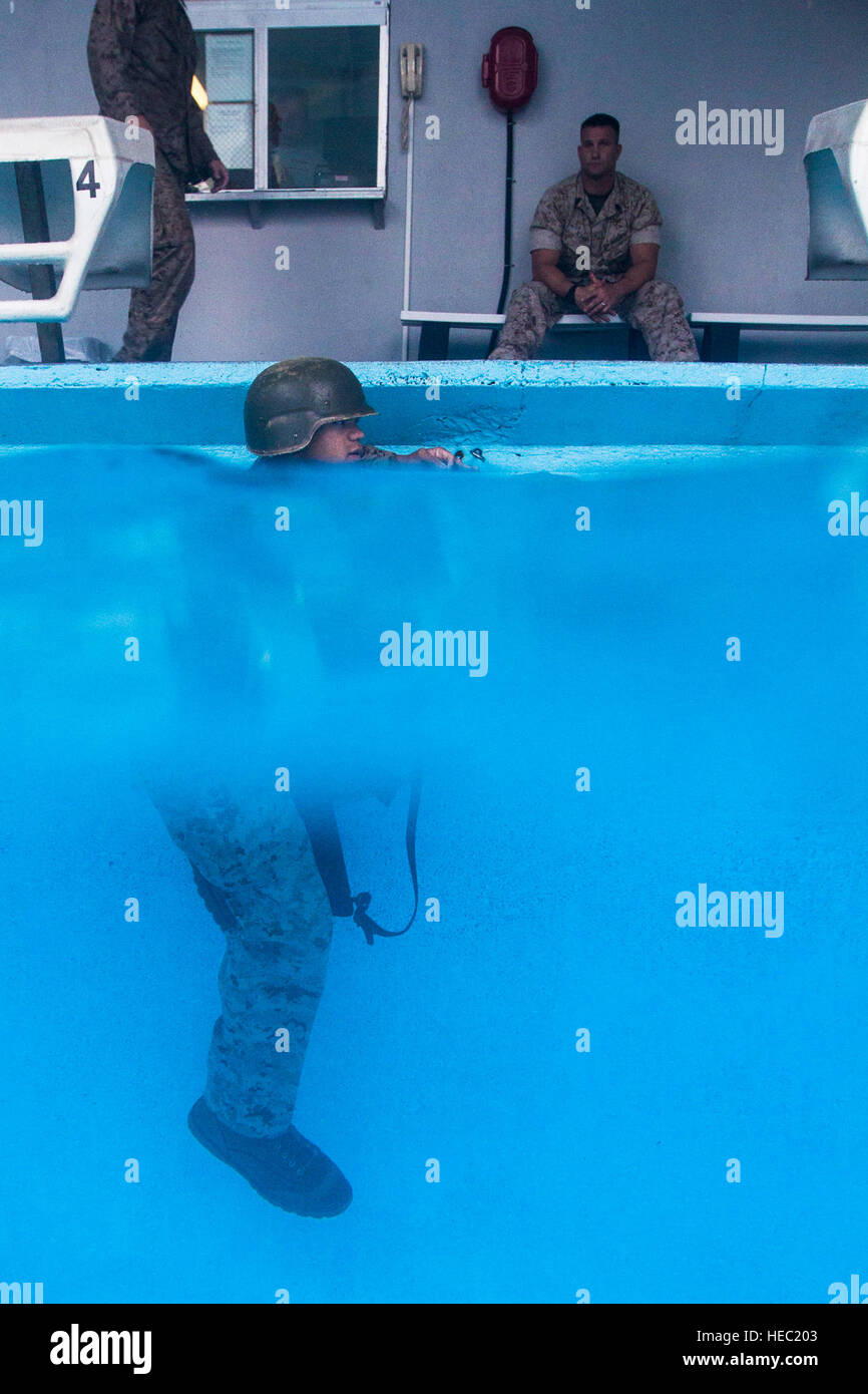 A U.S. Marine with the 3rd Battalion, 8th Marine Regiment holds onto ...