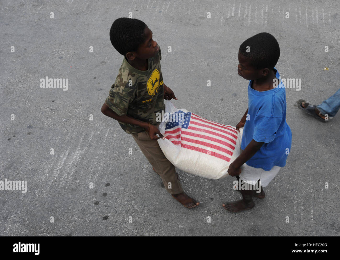 Haitians receive bags of rice in front of the Presidential Palace in ...