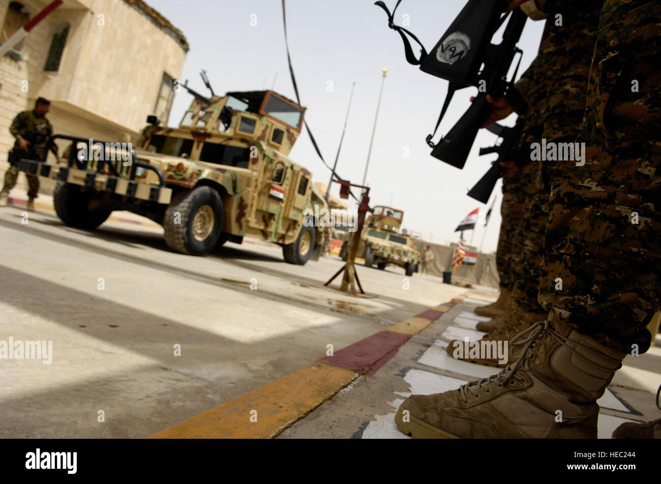 Iraqi soldiers stand at attention during the departure of the official ...