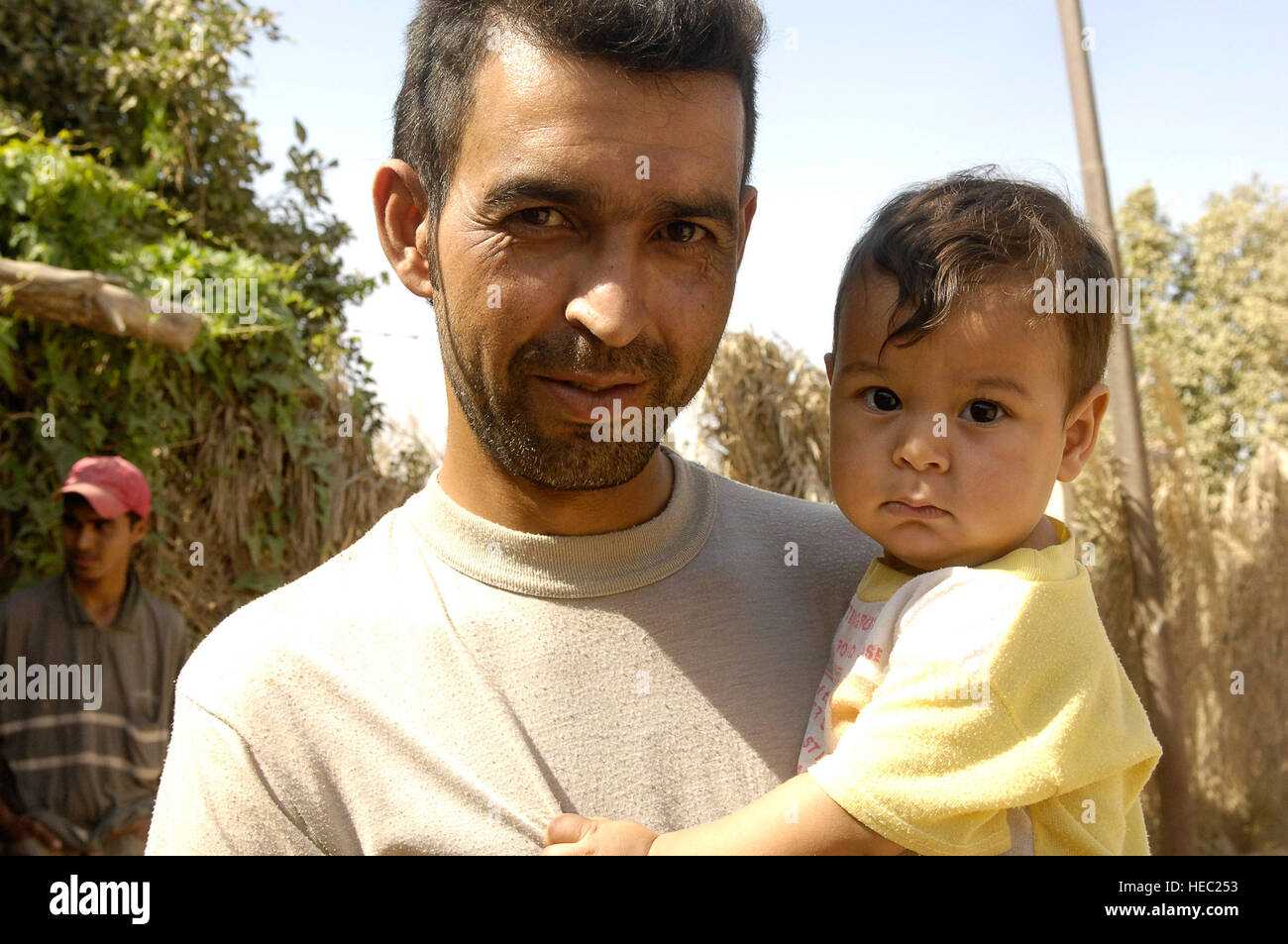 An Iraqi father and his baby greet U.S. Soldiers with 1st Brigade ...
