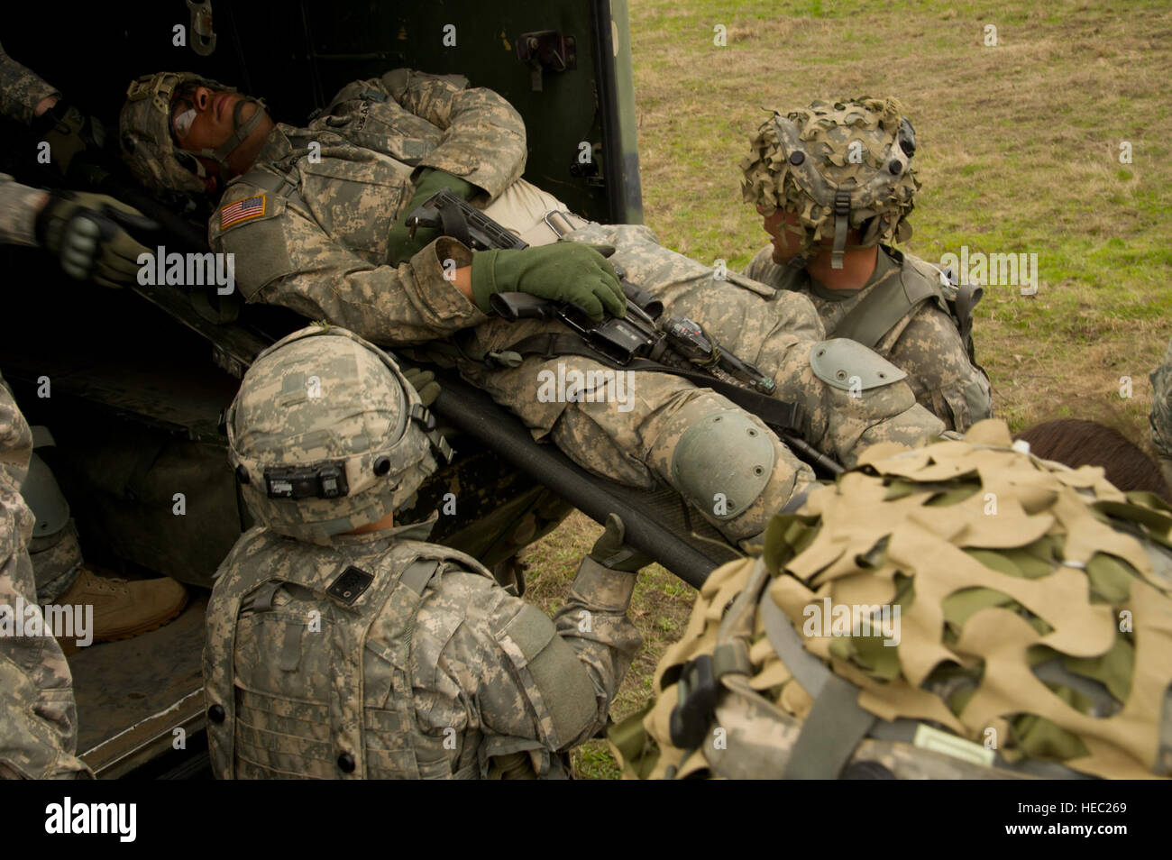 U.S. Soldiers unload a simulated patient from the back of an M997 ...