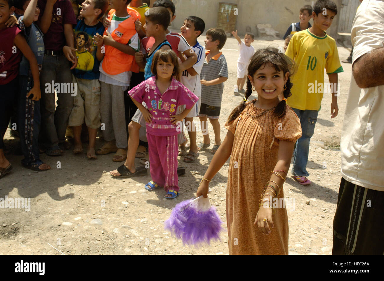 An Iraqi girl smiles in excitement as U.S. Soldiers from Alpha Battery ...