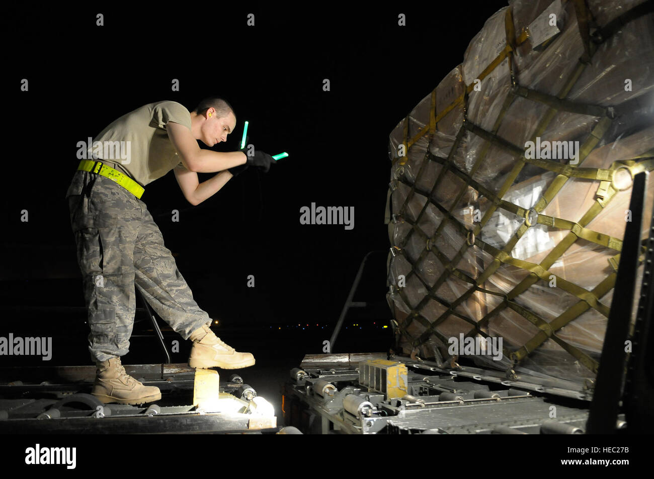 U.S. Air Force Airman 1st Class Daniel Anderson marshals a 60k loader ...