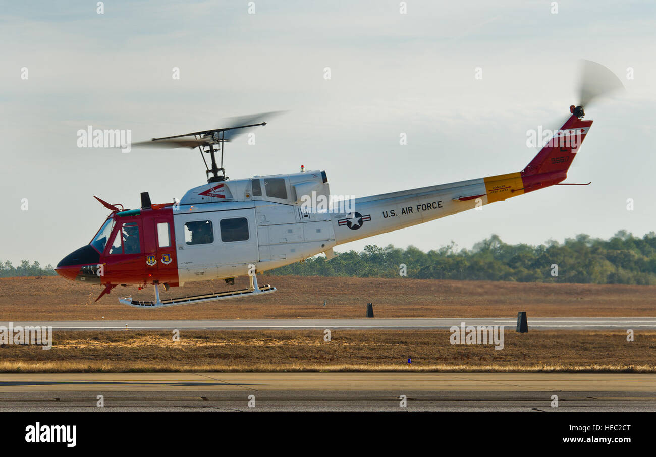 A 413th Flight Test Squadron UH-1 Huey lifts off from the flightline at ...