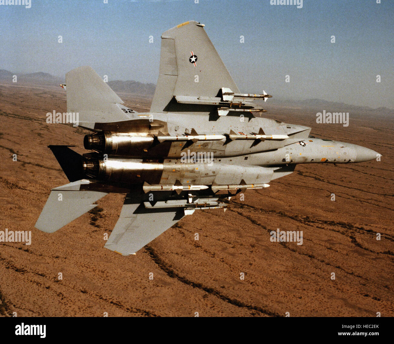 An air-to-air underside view of an F-15 Eagle aircraft from the 555th ...