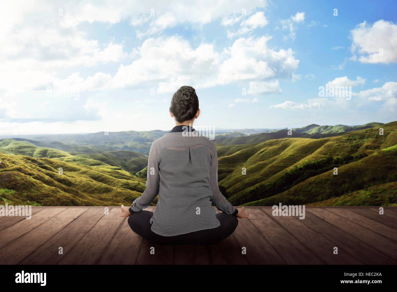 Rear view of asian woman doing meditation on the wooden floor with ...
