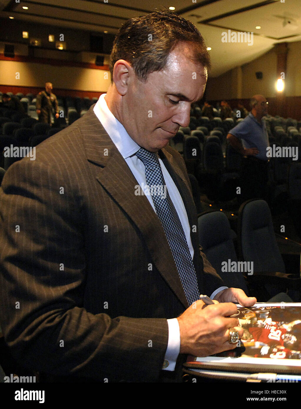 Ricky Ellison, former linebacker for the San Francisco 49ers, signs an ...