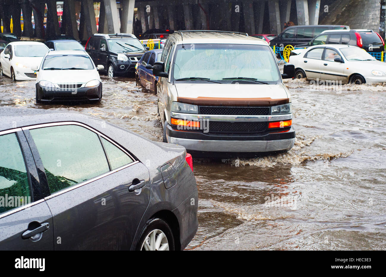 Road traffic on flooded road in heavy rain hi-res stock photography and ...