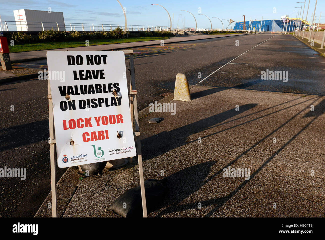 Warning sign on empty car park Stock Photo - Alamy