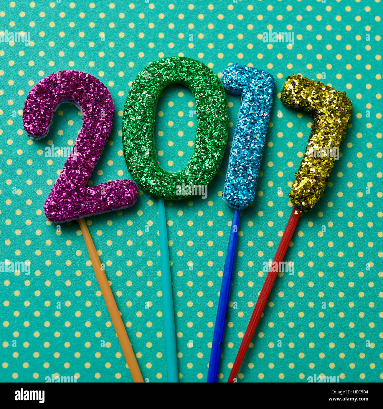 closeup of four glittering numbers of different colors forming the ...