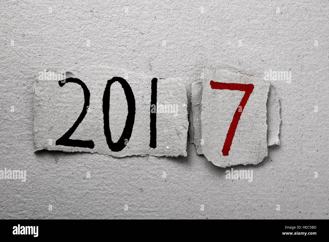 the number 2017, as the new year, handwritten in some pieces of rustic ...