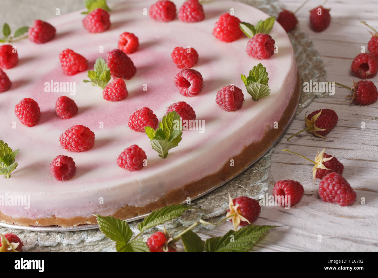 Big round raspberry cheese cake with mint and berries close up on the ...