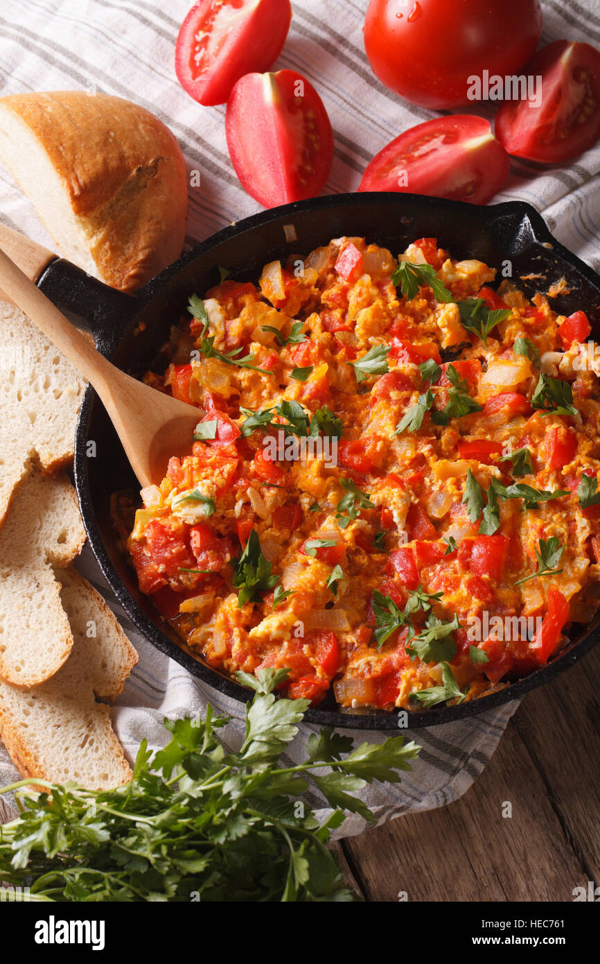 Turkish Menemen omelet with vegetables close-up in a frying pan ...