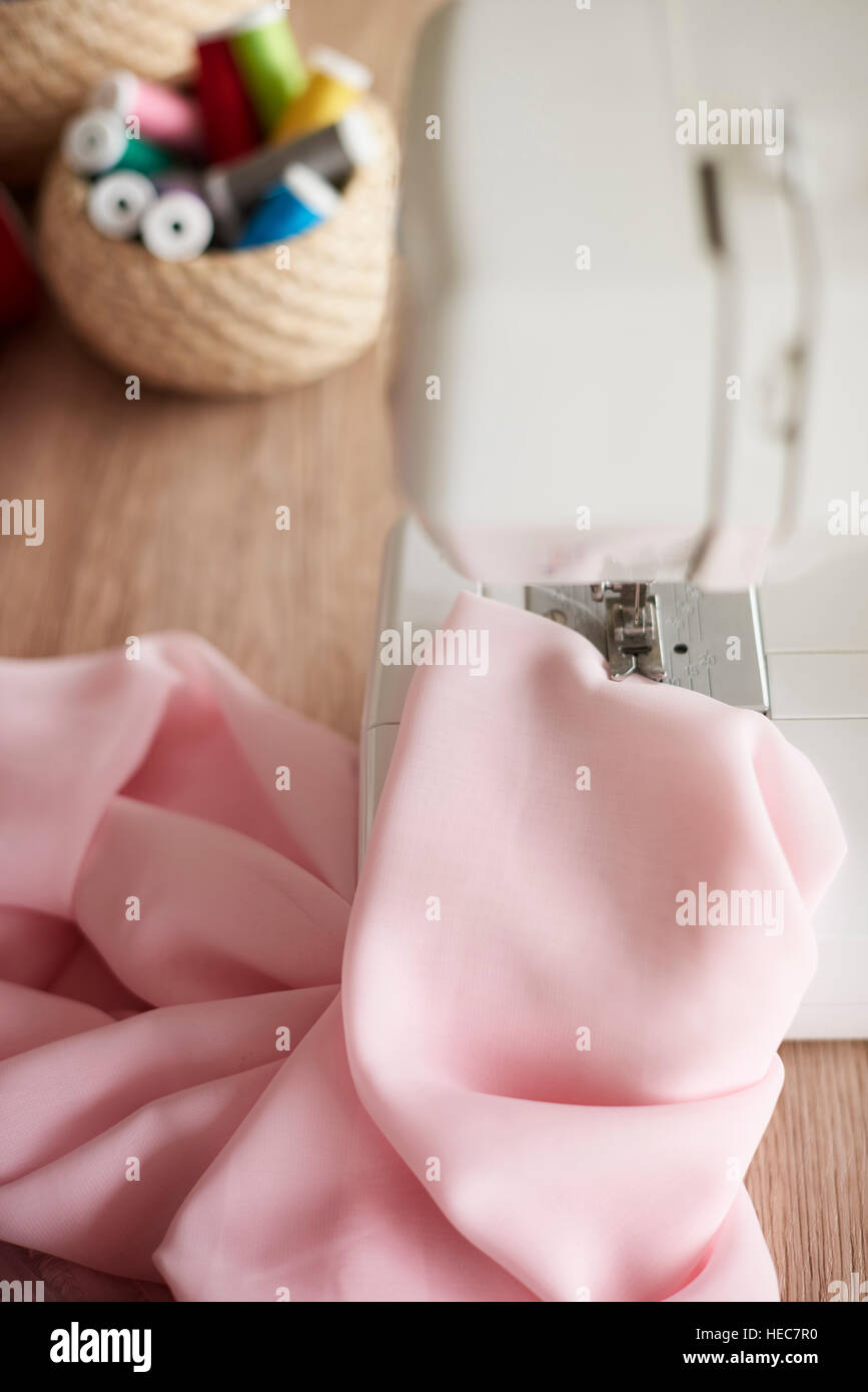 Sewing machine and pink fabric Stock Photo - Alamy