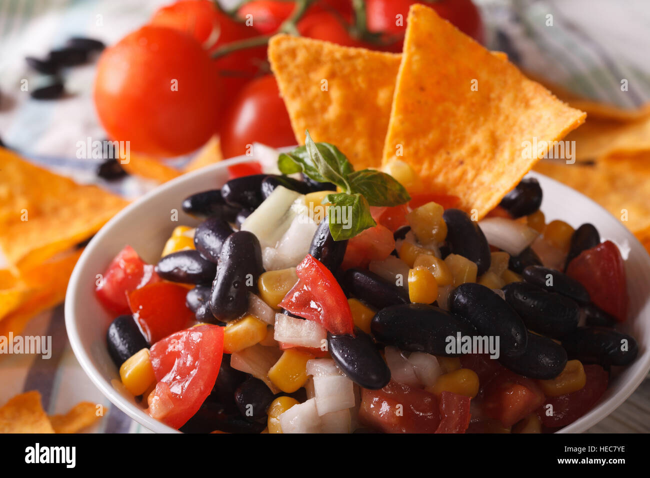 Mexican salsa with black beans and fresh vegetables in a bowl and corn ...