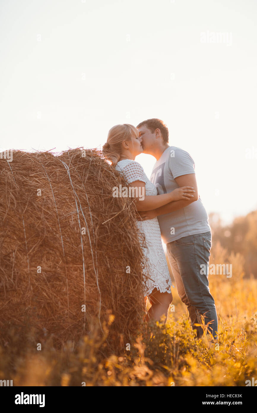 love story man and woman on the background of haystacks and sun Stock ...