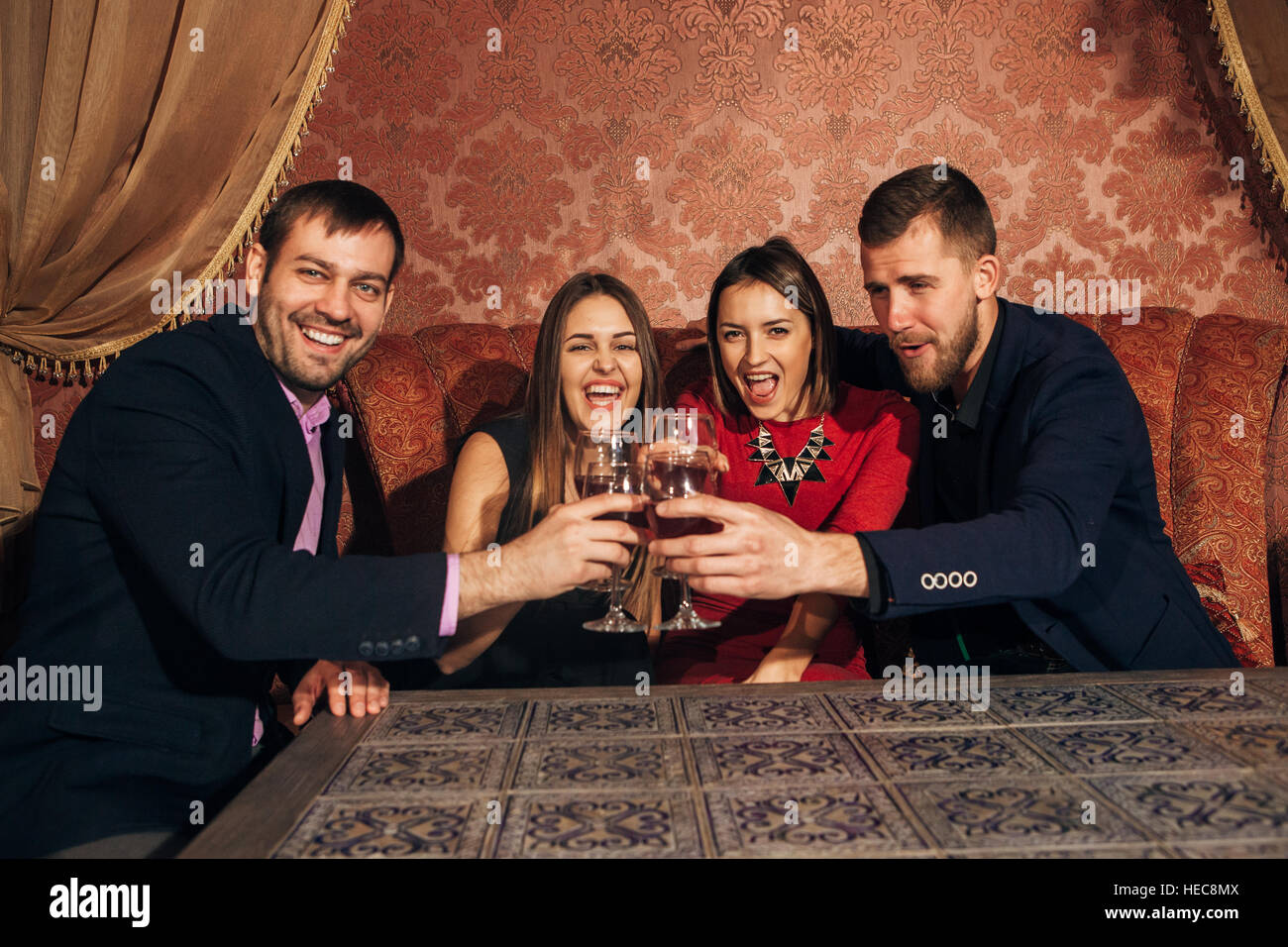Two happy smiling young couples with champagne at celebration Stock ...