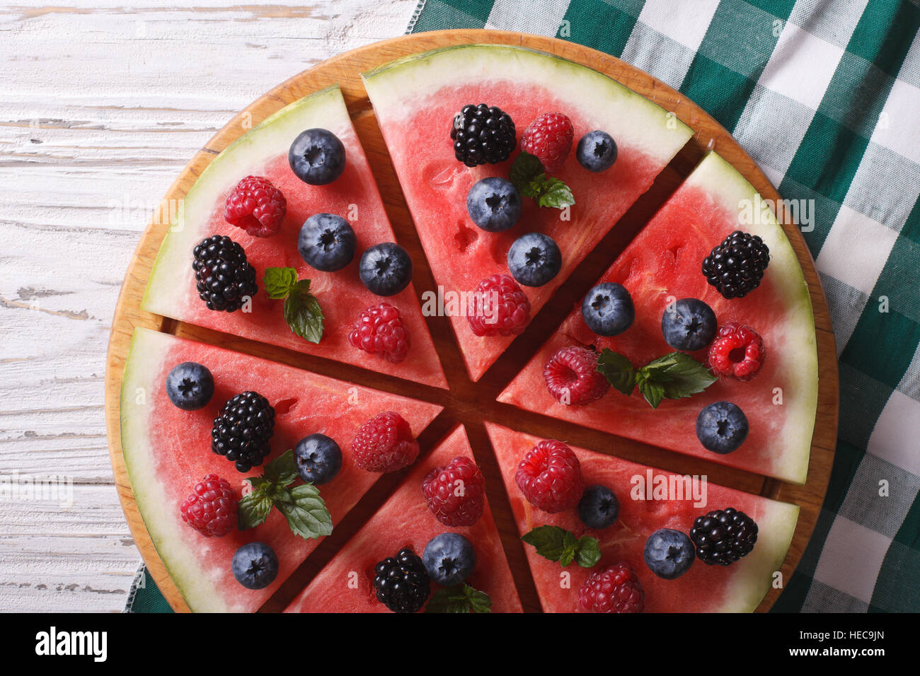 Watermelon decorated with raspberries and blueberries close-up on the ...