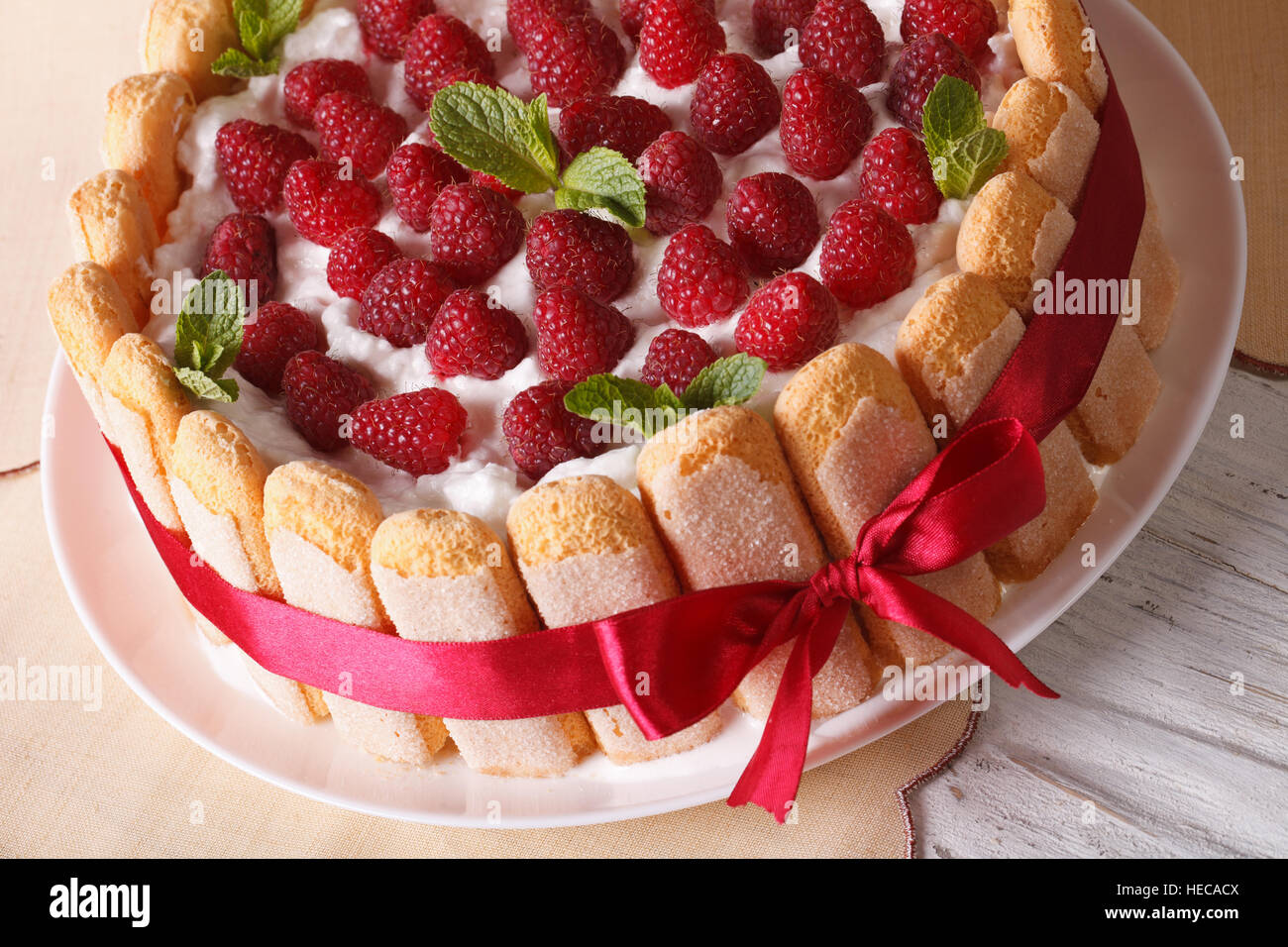 raspberry charlotte cake with Savoiardi close-up on the table ...