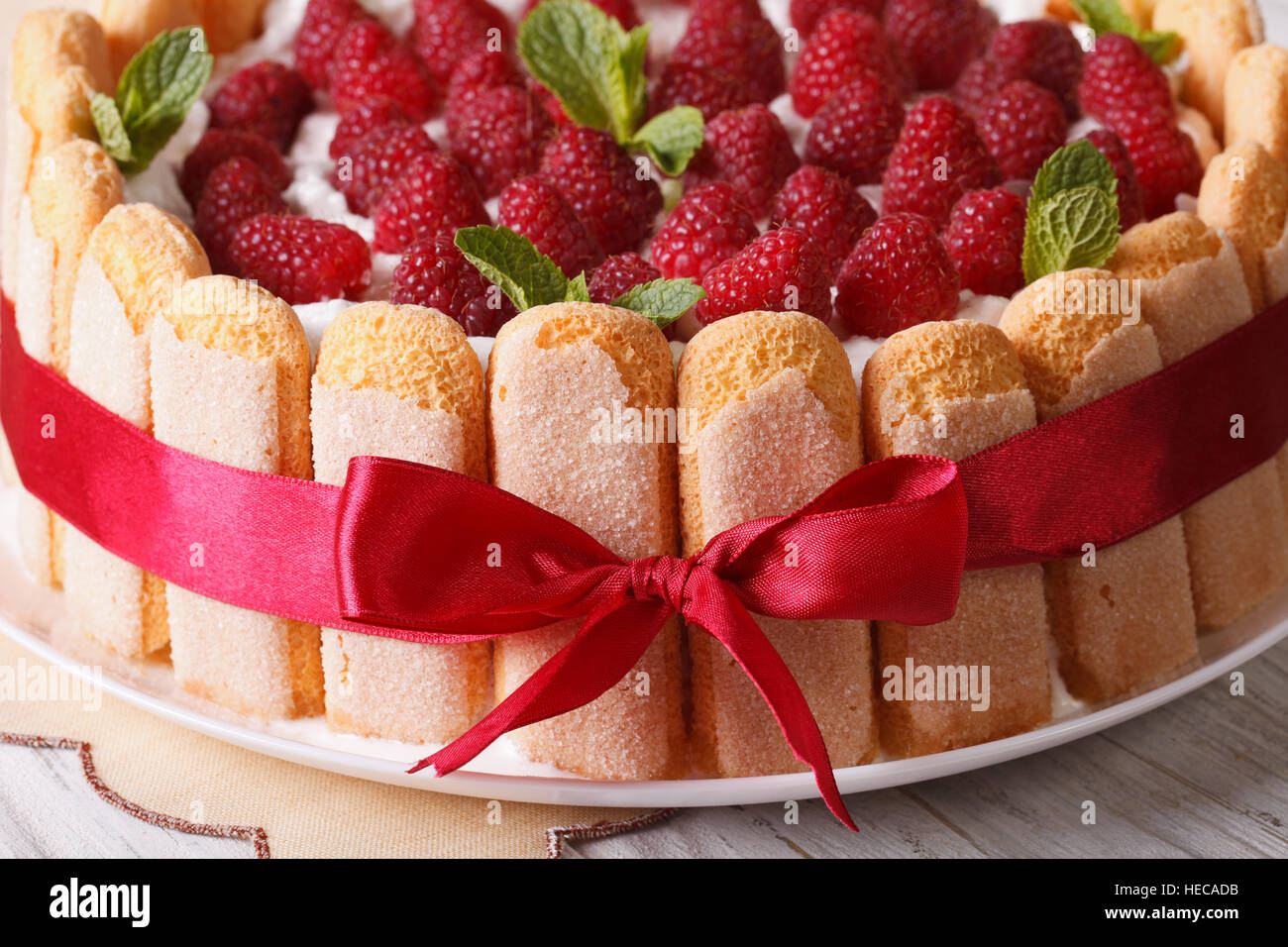 Beautiful raspberry charlotte cake with Savoiardi macro on a plate ...