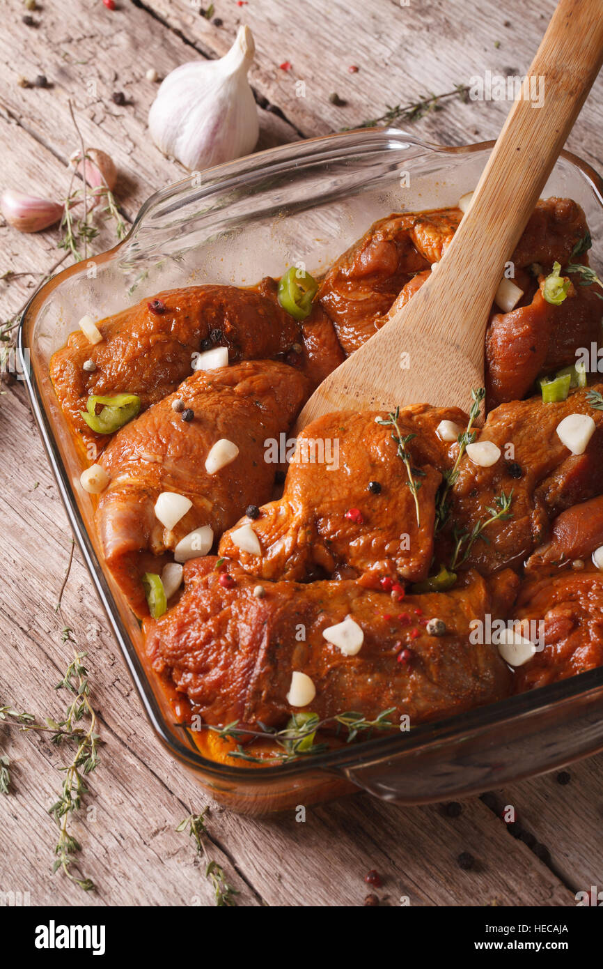 Raw meat in a spicy red marinade in a bowl close up on the table ...