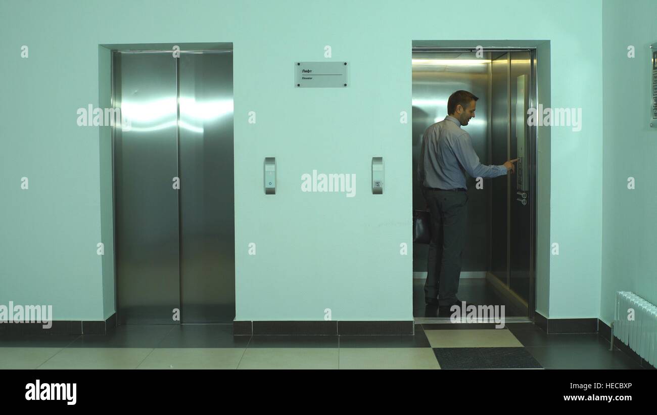 young businessman waiting for Elevator Stock Photo - Alamy