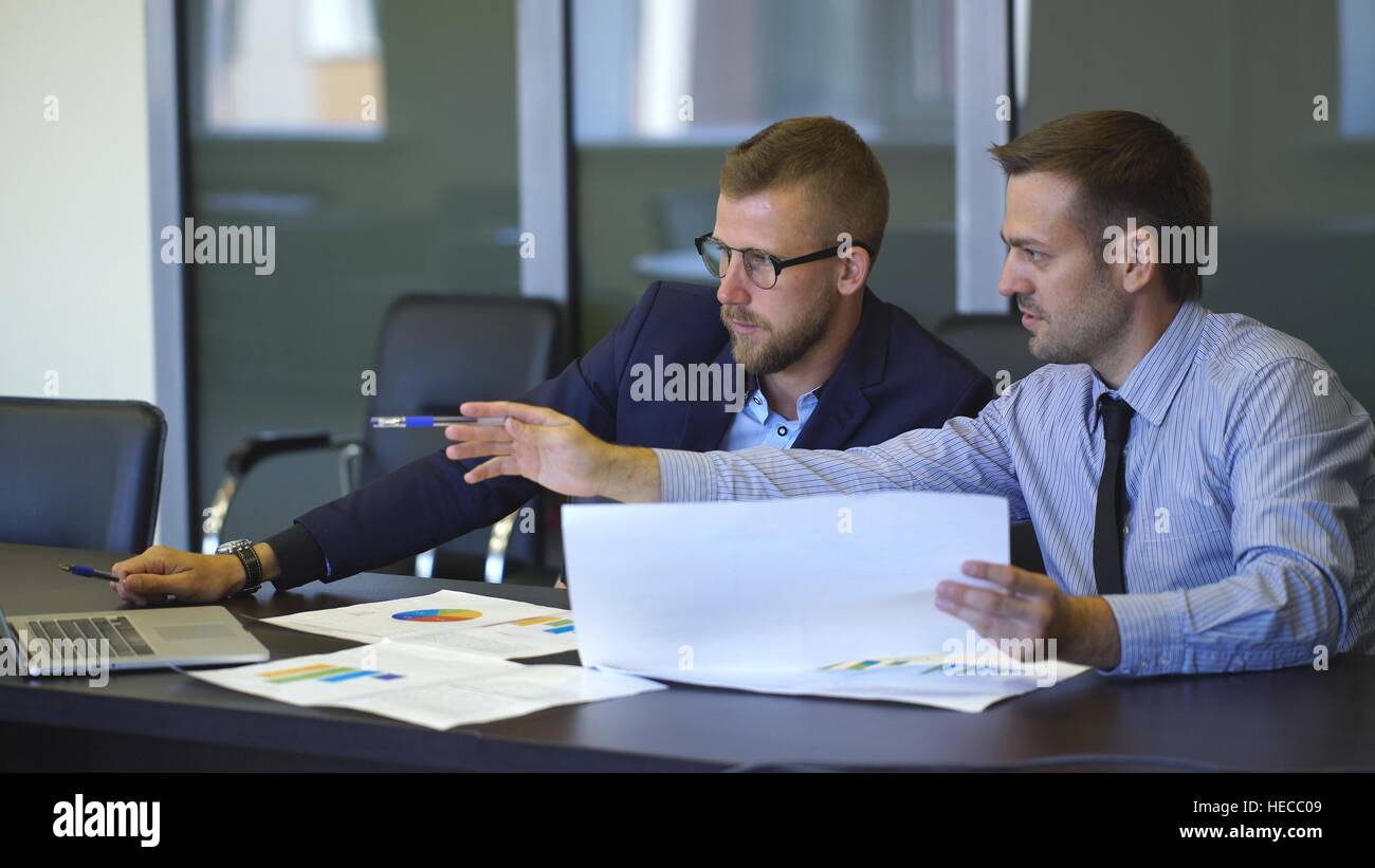 two businessmen in a business meeting discussing graphics Stock Photo ...