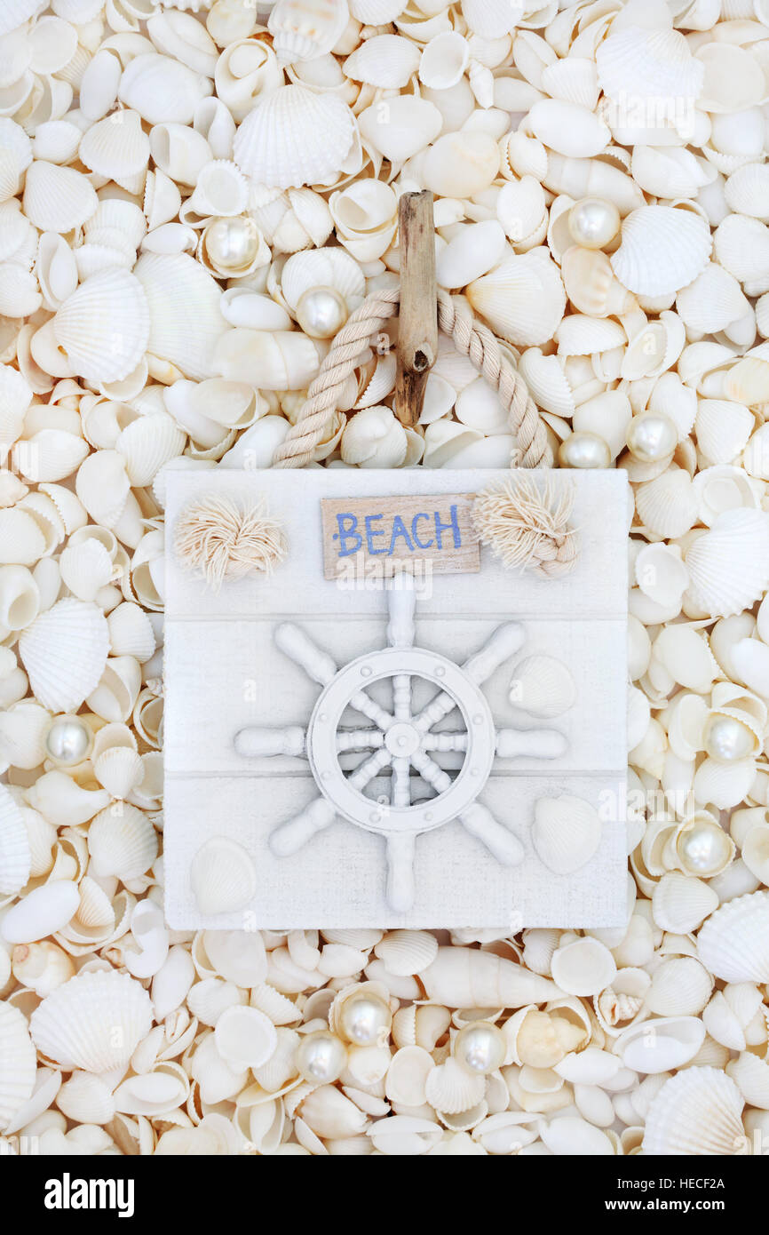 Wooden beach sign with pearls and assorted white seashells Stock Photo ...
