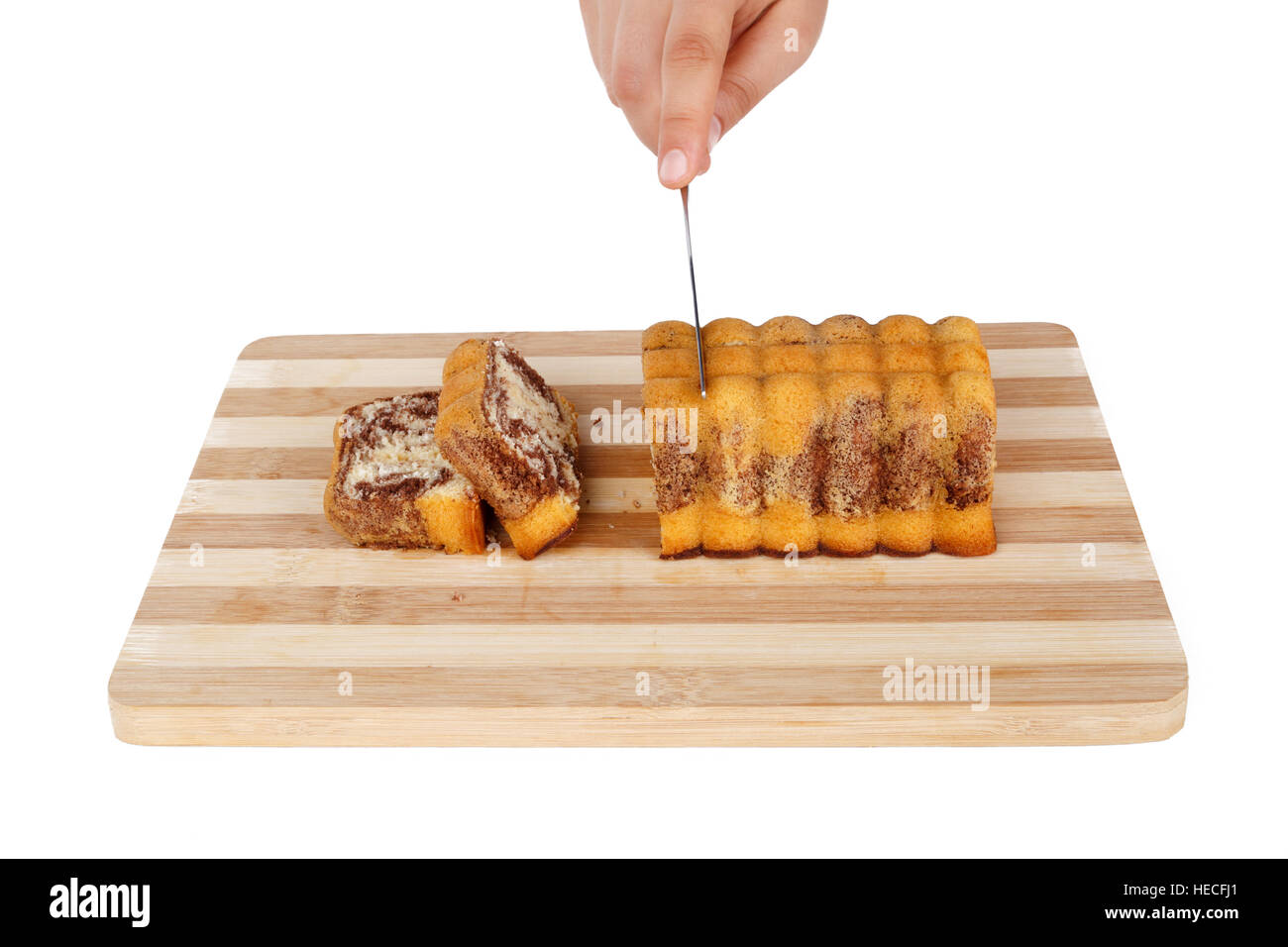 Close up detailed side view of cacao cake, woman hand slicing with a ...