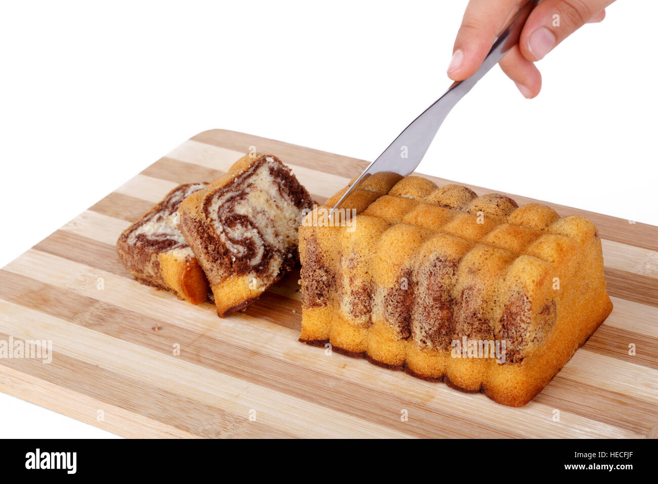 Close up detailed side view of cacao cake, woman hand slicing with a ...