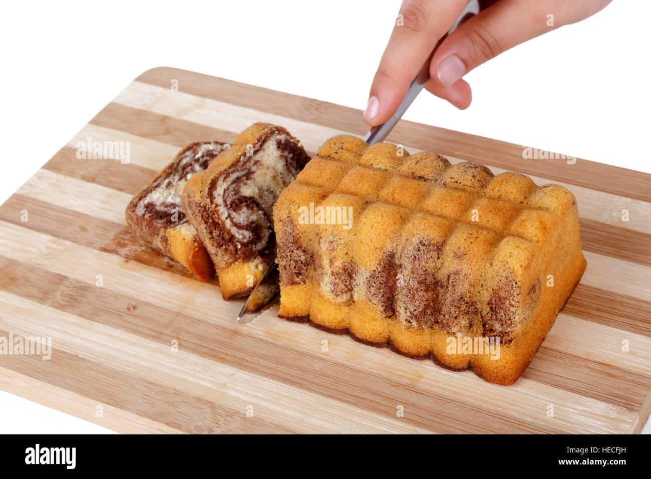 Close up detailed side view of cacao cake, woman hand slicing with a ...