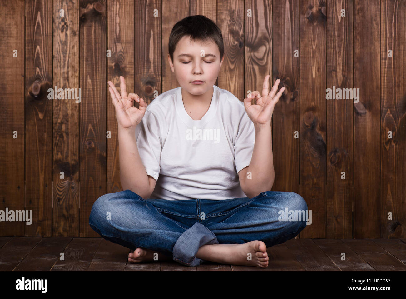 Boy in a suit in lotus position Stock Photo - Alamy