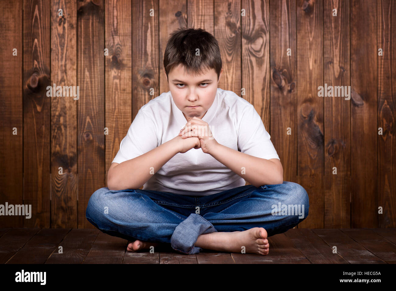Boy in a suit in lotus position Stock Photo - Alamy